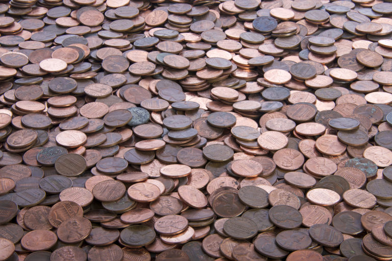 many old dirty pennies. bronze and copper pennies scattered on t ...